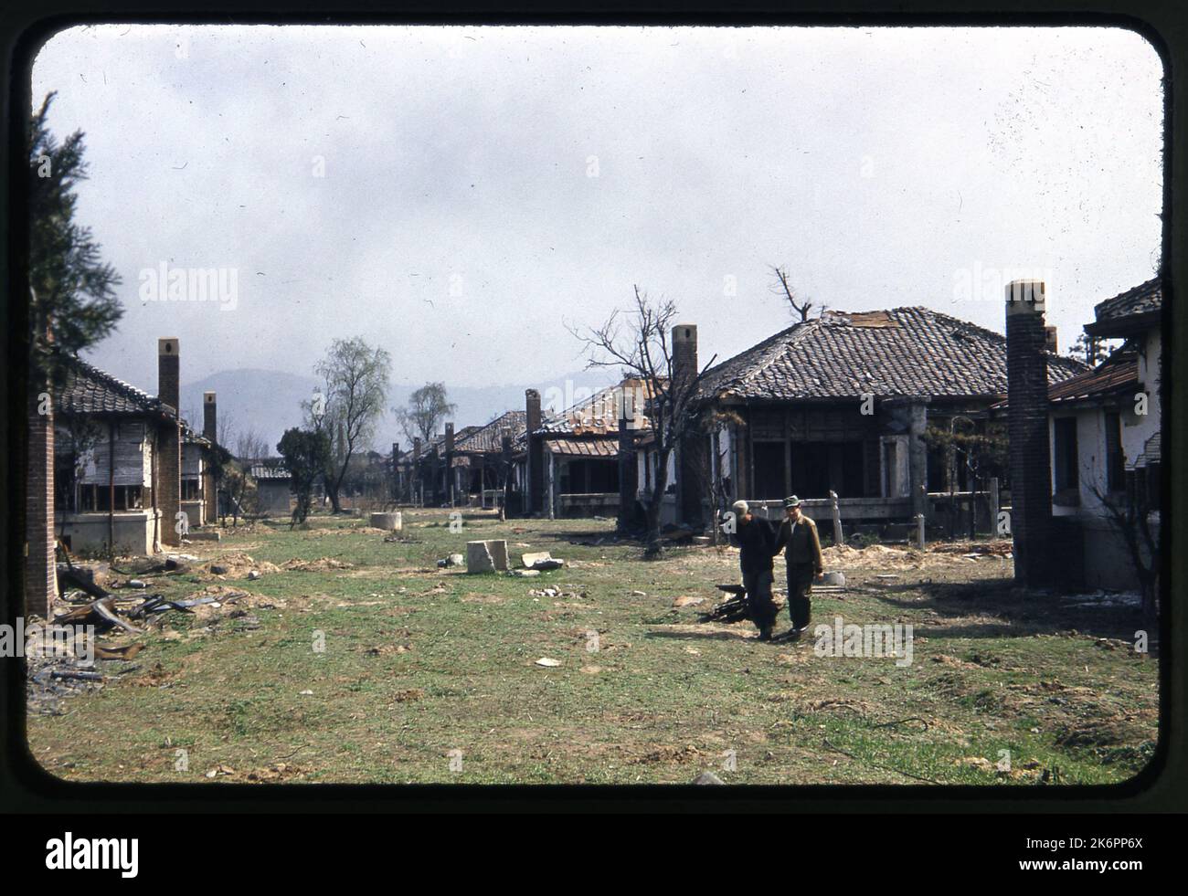 Neighborhood scene of houses in decay. All houses in photo are falling ...