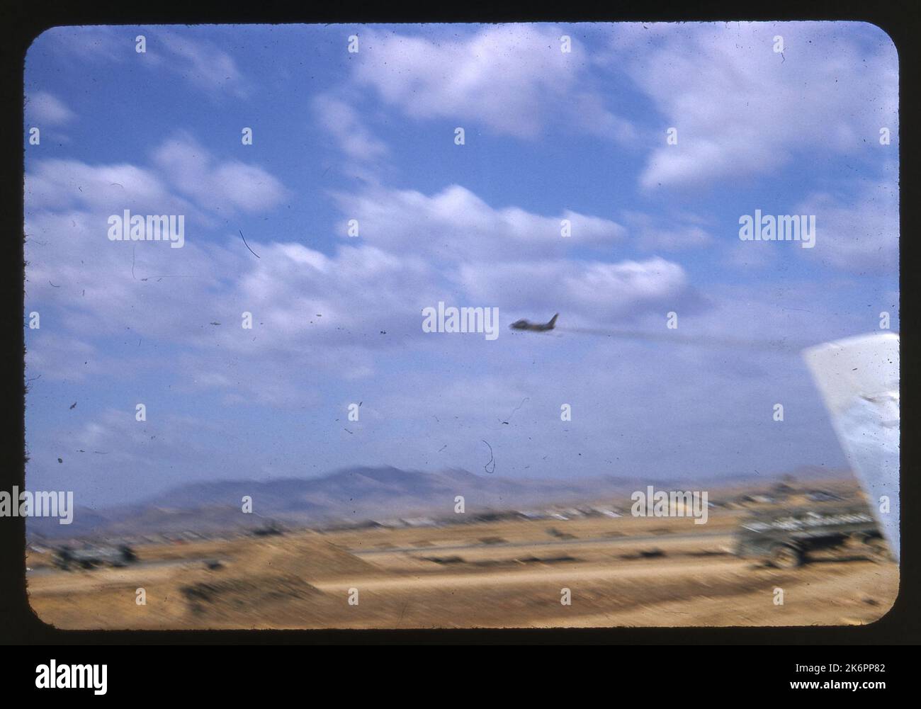 Left side view of a North American F-86D Sabre streaking across the sky ...