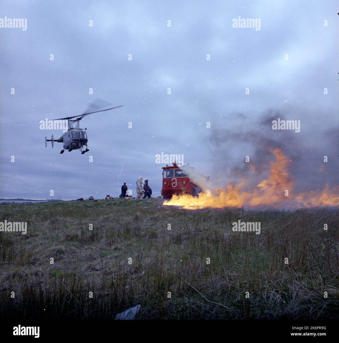 Norwegian and American Firemen Fight a Fire as an HH-43 Helicopter ...