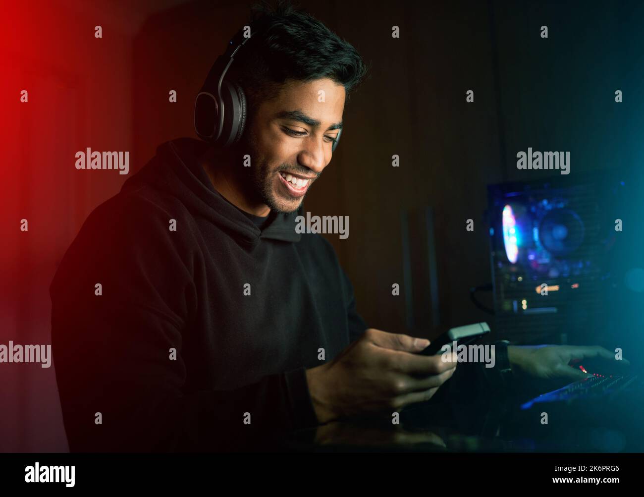 Texting the squad. a handsome young male gamer playing video games in a ...