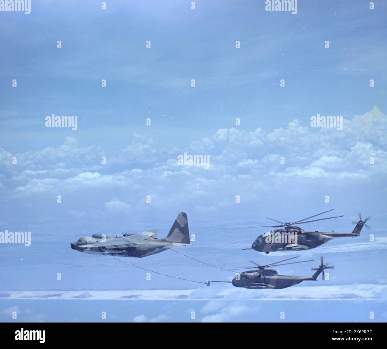 Side View of HC-130P Refueling an HH-3 and HH-53B. Side View of HC-130P ...