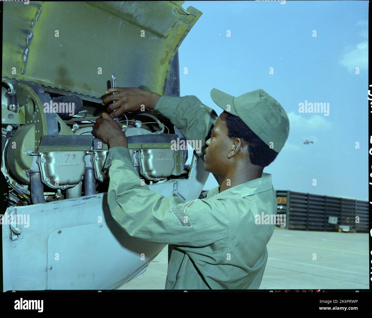 Airman 1st Class Gregory J. Anderson Works on the Engine of an O-1 ...
