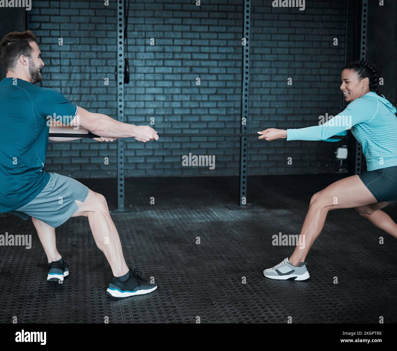 Ready to welcome the challenge. two people pulling on a rope in tug of ...