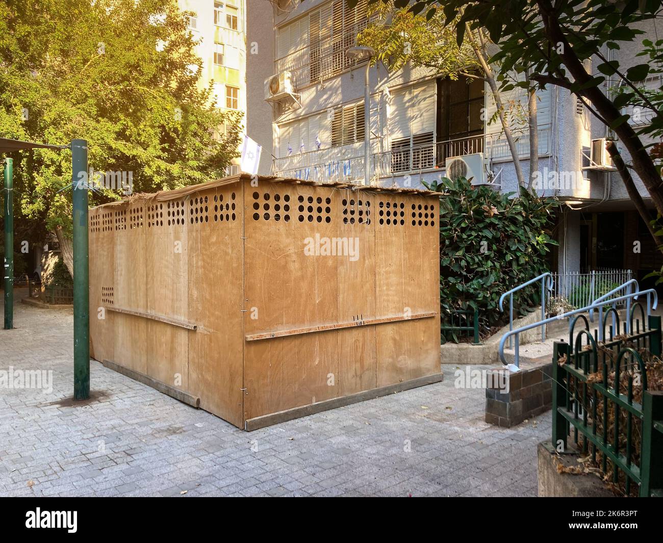 Wooden sukkah in a yard of a residential building in Israeli town ...
