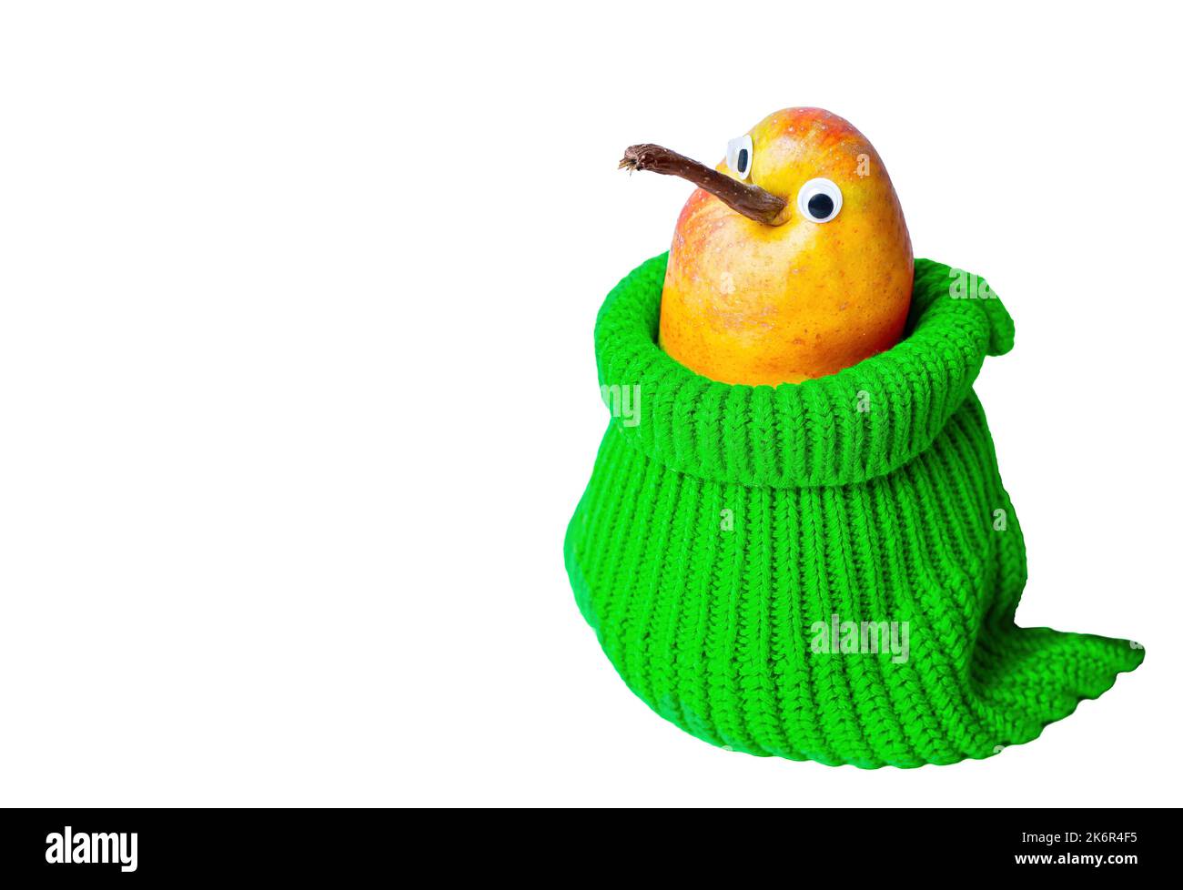 Close-up of a cute anthropomorphic pear with googly eyes placed inside ...