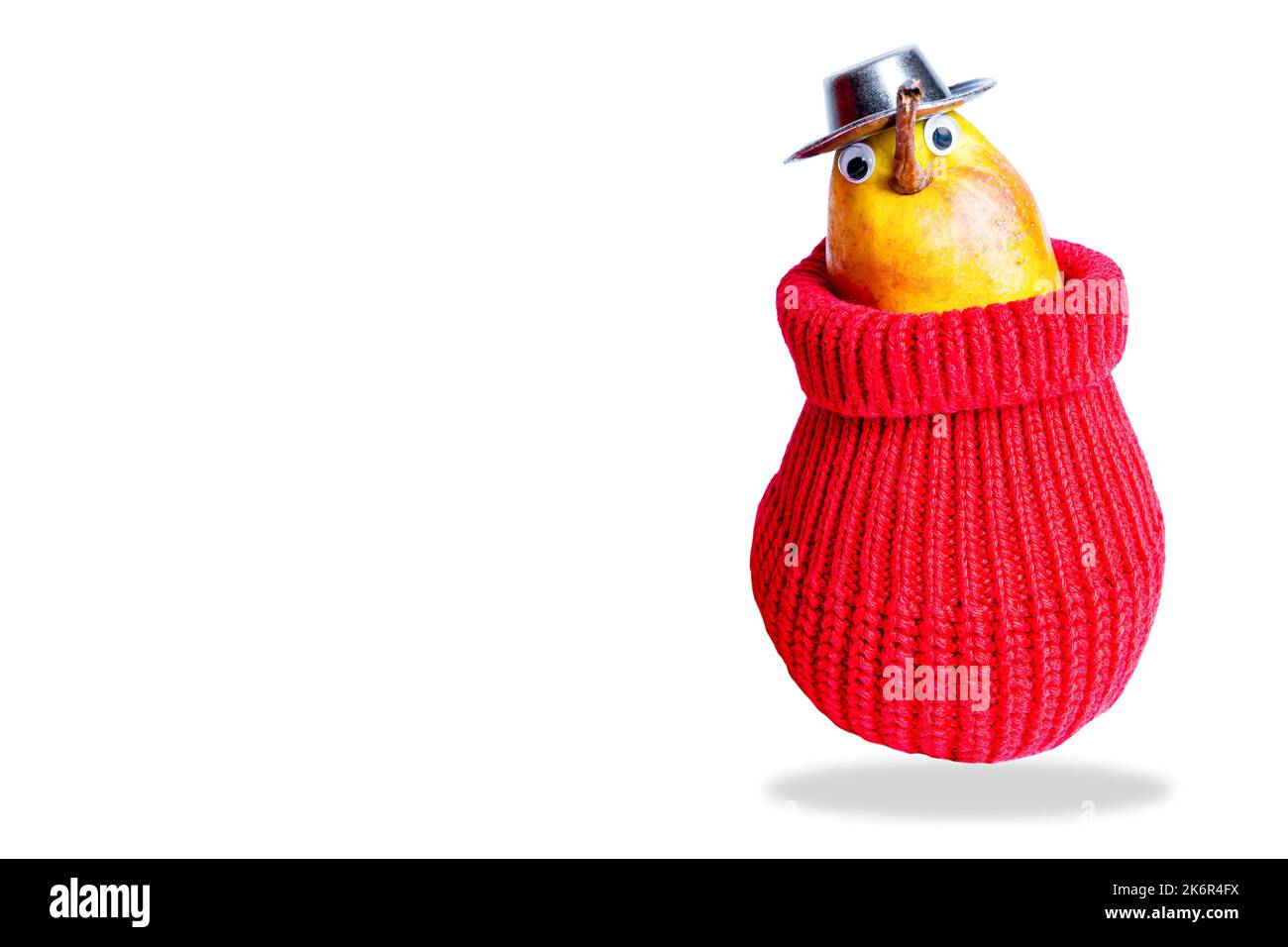 Close-up of a cute anthropomorphic pear with googly eyes wearing a ...