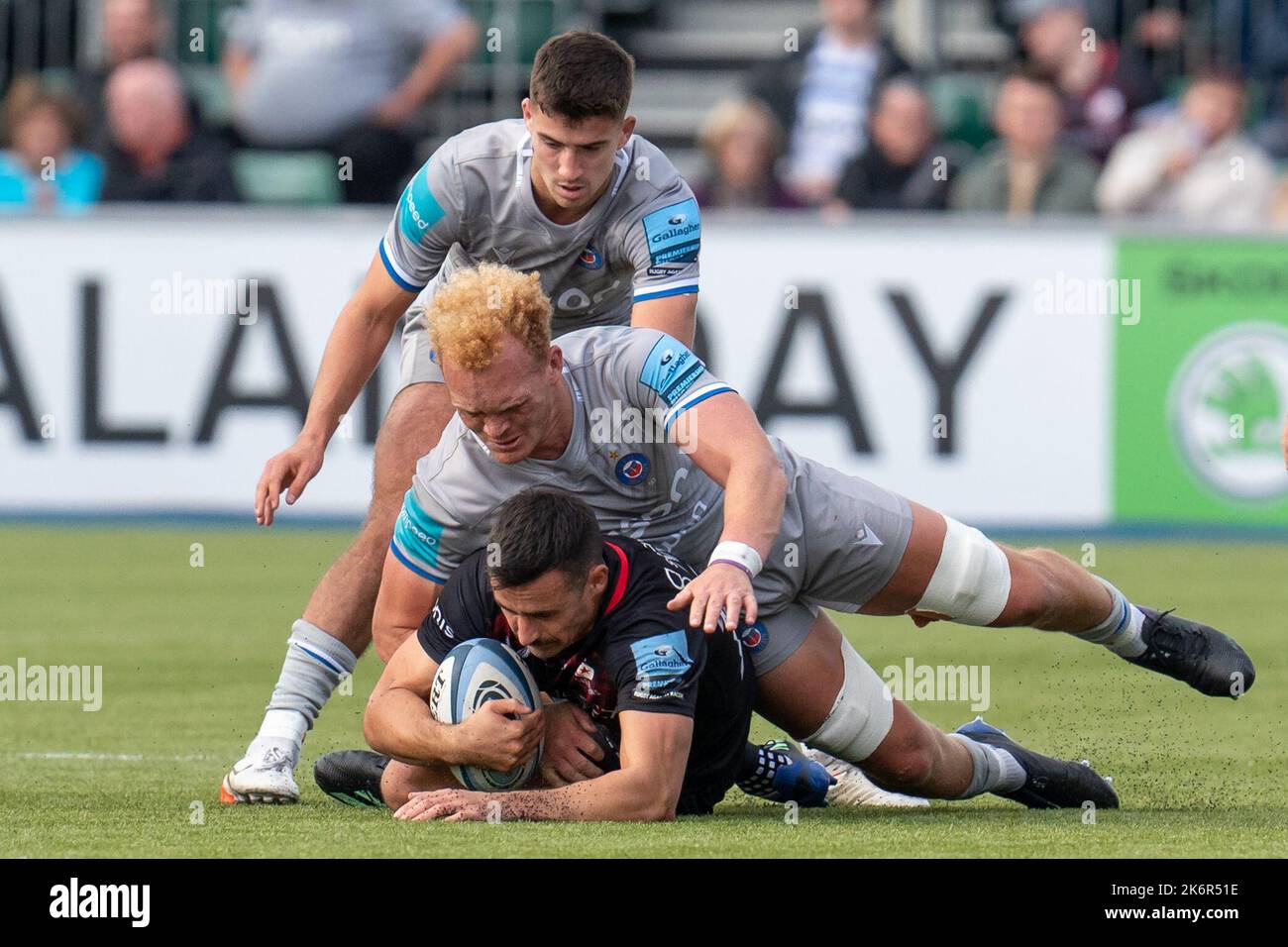 Alex Lowowski #12 of Saracens is tackles by Miles Reid #7 of Bath Rugby ...
