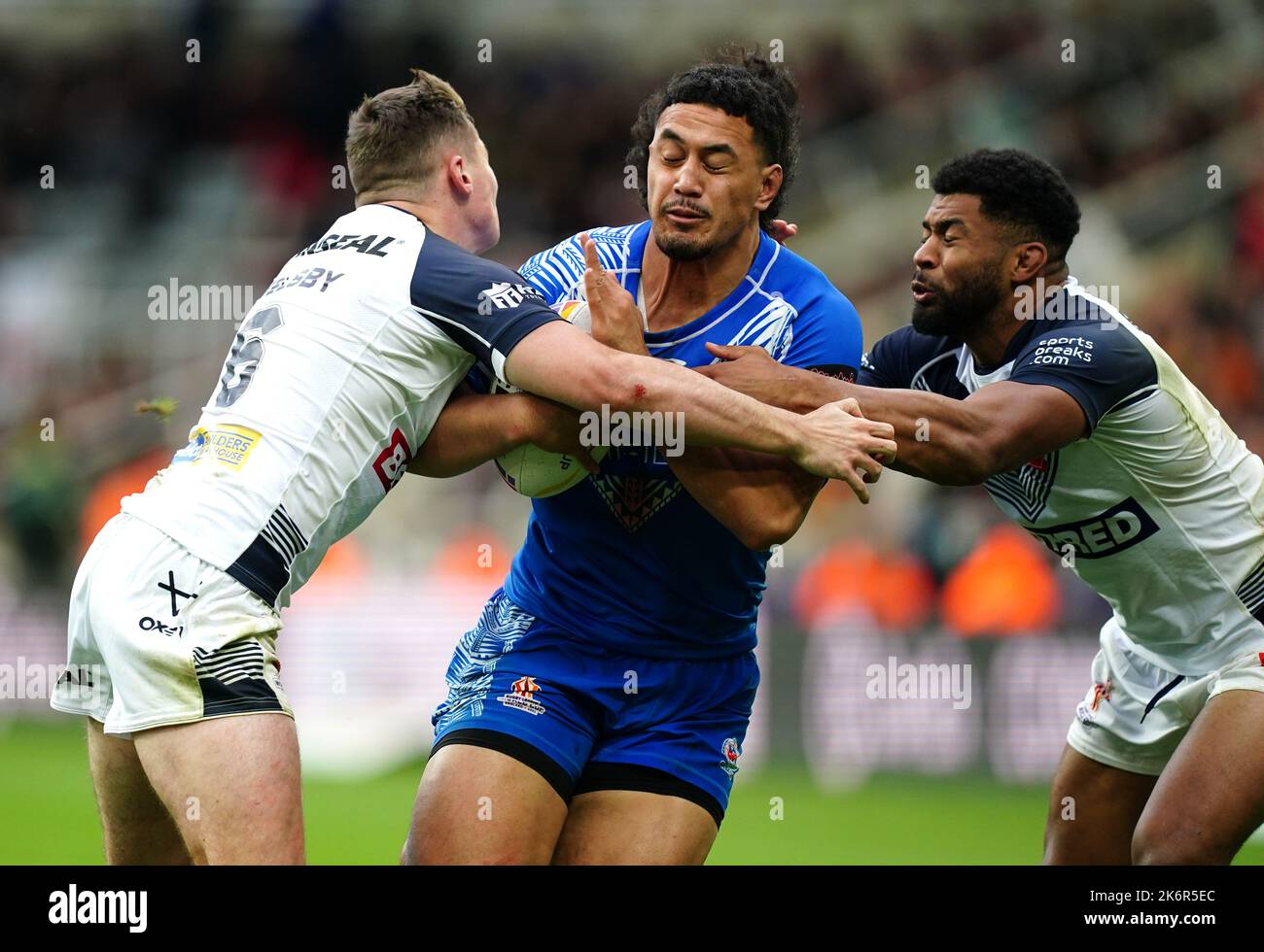 Samoa's Kelma Tuilagi is tackled by England's Jack Welsby (left) and ...