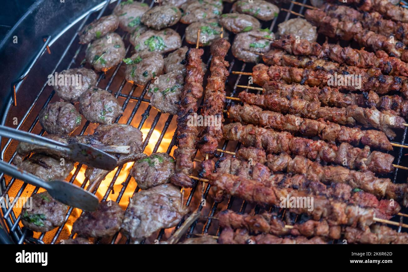 hot grilled lamb meat on skewers and meatballs barbecued on open ...