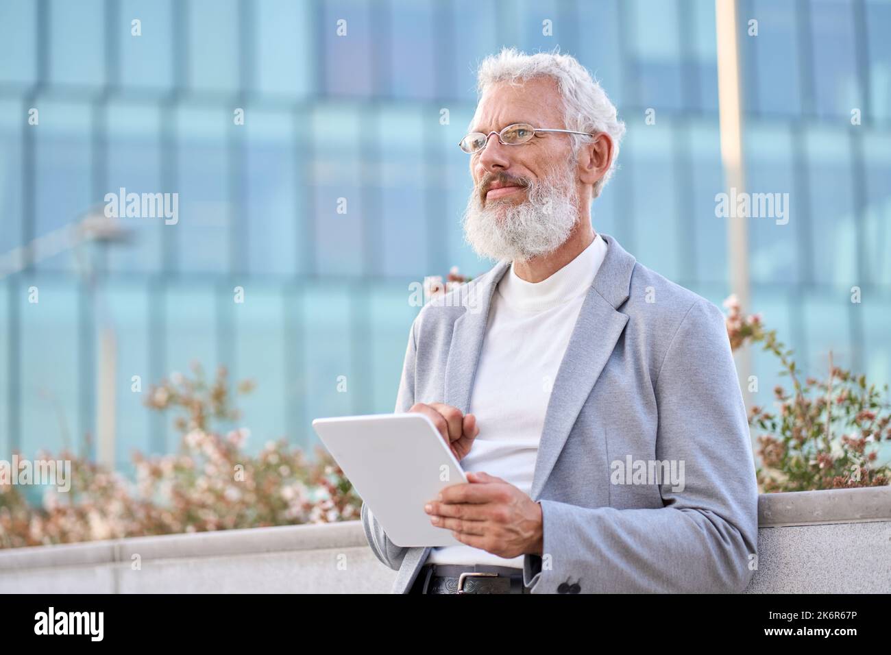 Old senior professional business man using digital tablet thinking ...