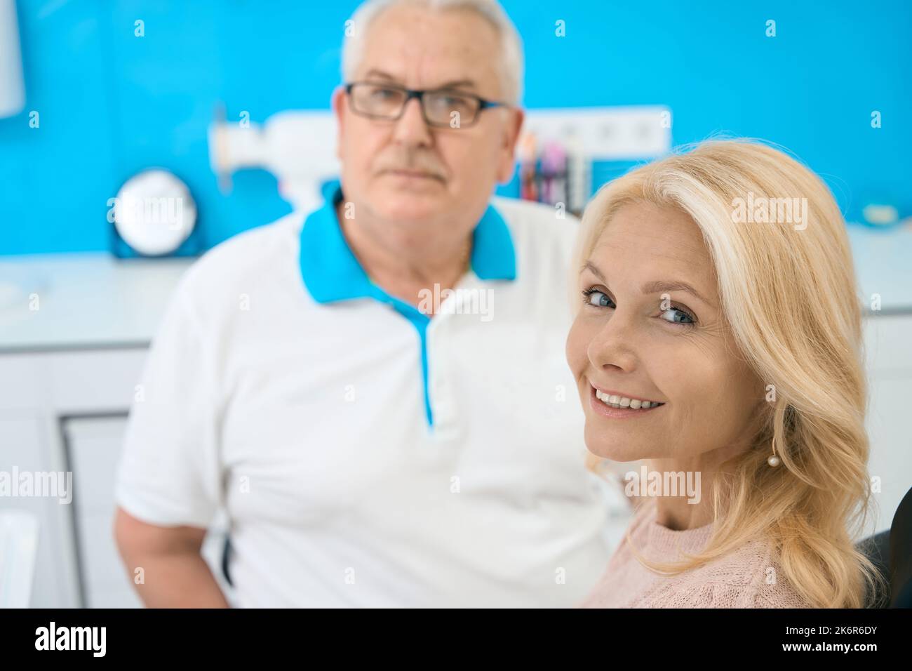 Happy positive female patient during the visit in stomatology center ...