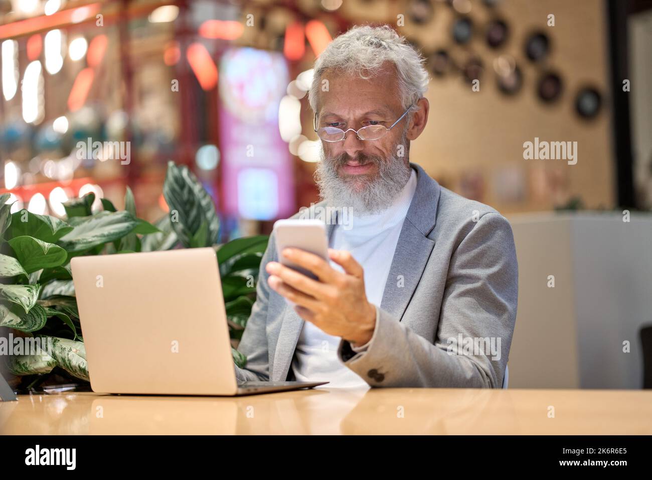 Older business man executive using mobile phone working late in office ...