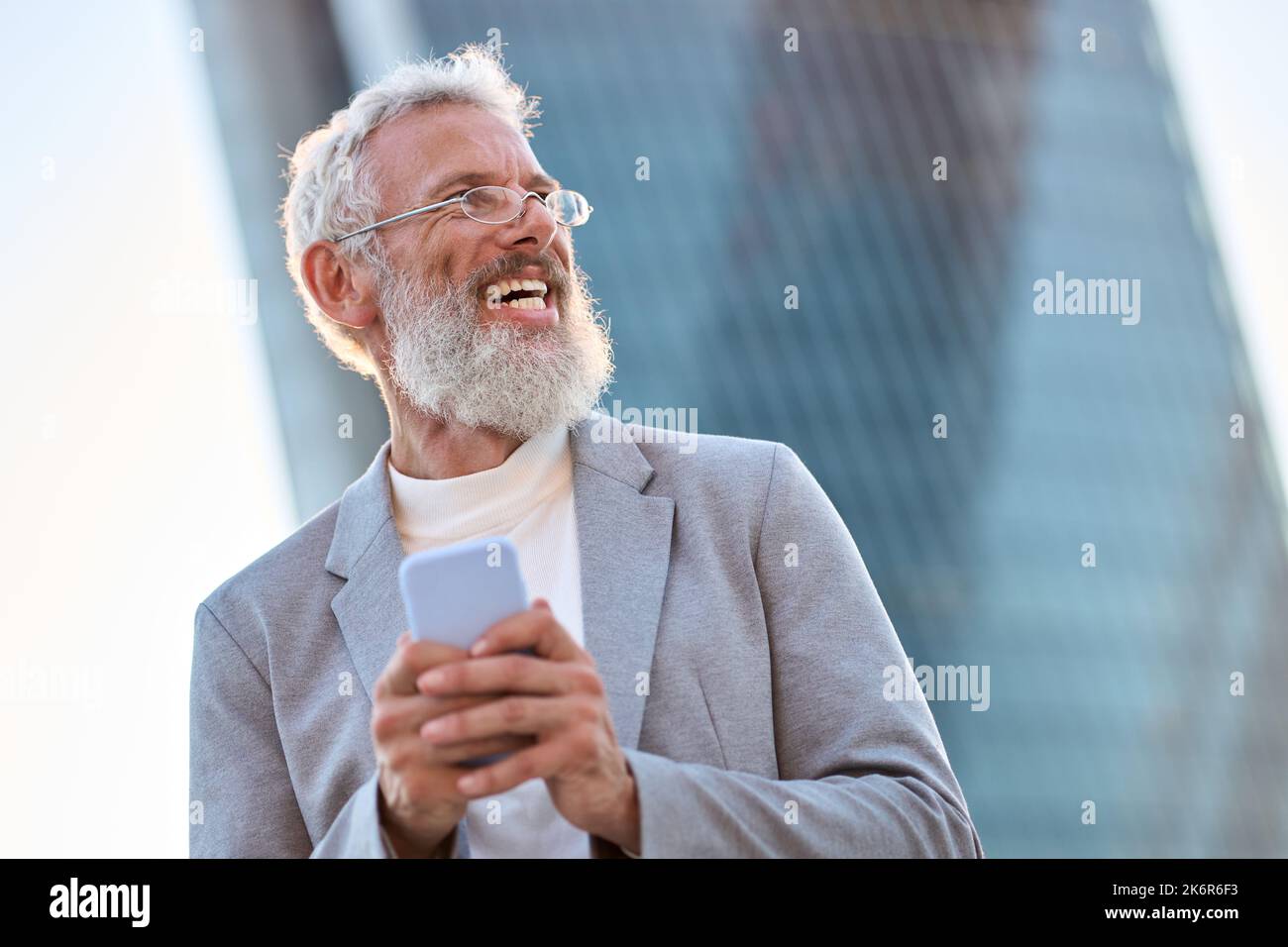Happy old professional business man holding phone using smartphone ...