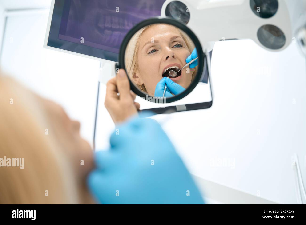 Beautiful lady is receiving professional teeth treatment in dental ...