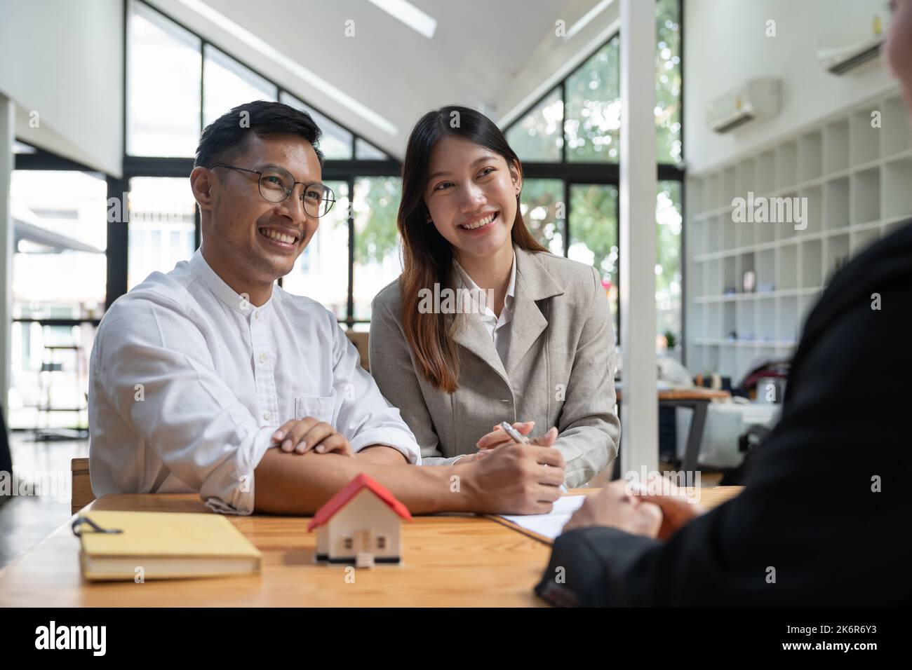 Happy property owners with real estate broker after a deal. Young ...