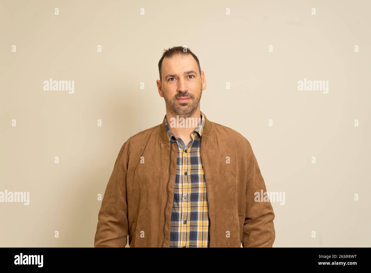 Hispanic man in his 40s with a beard posing smiling wearing a brown ...