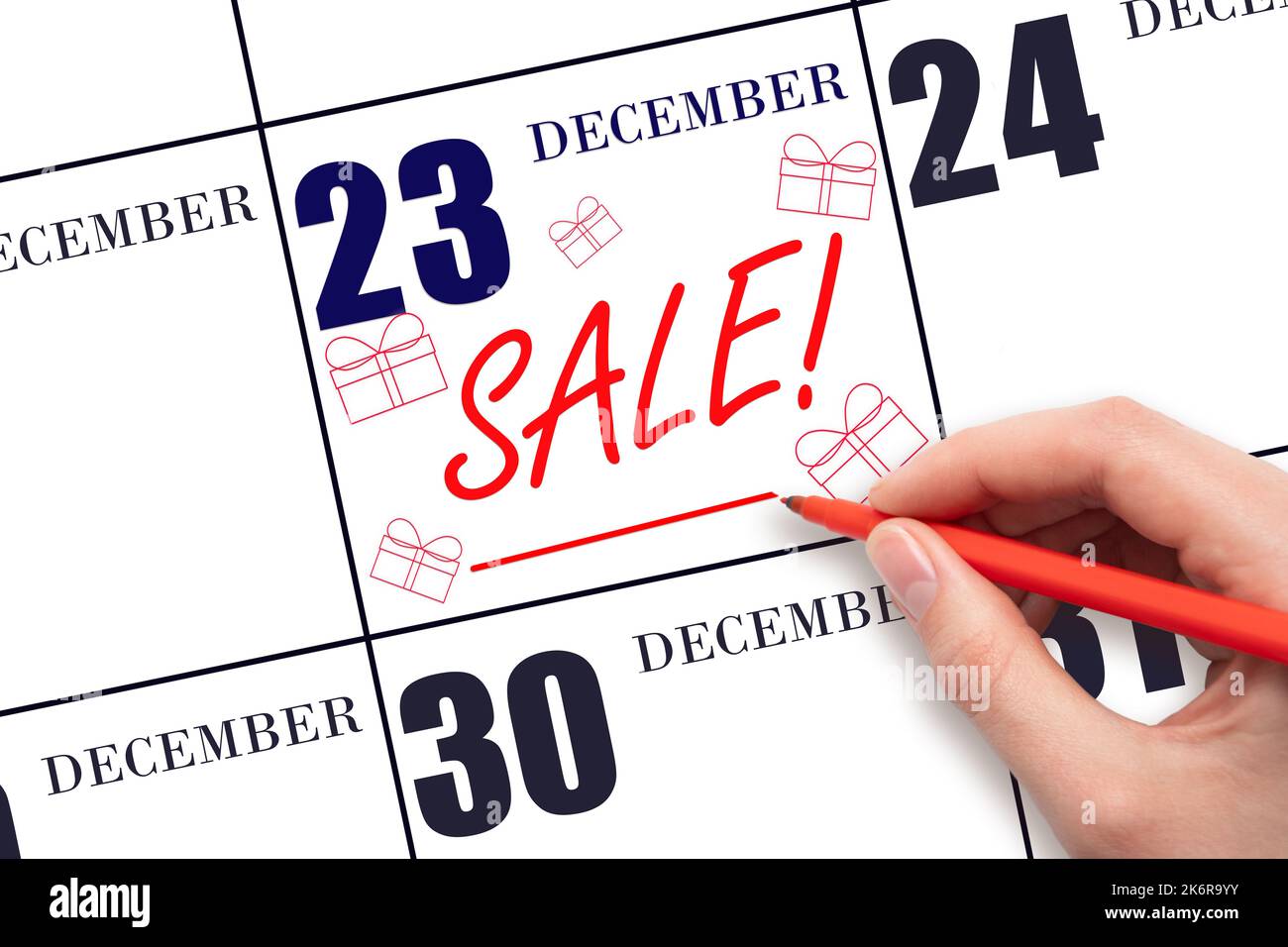 23rd day of December. Hand writing text SALE and drawing gift boxes on ...