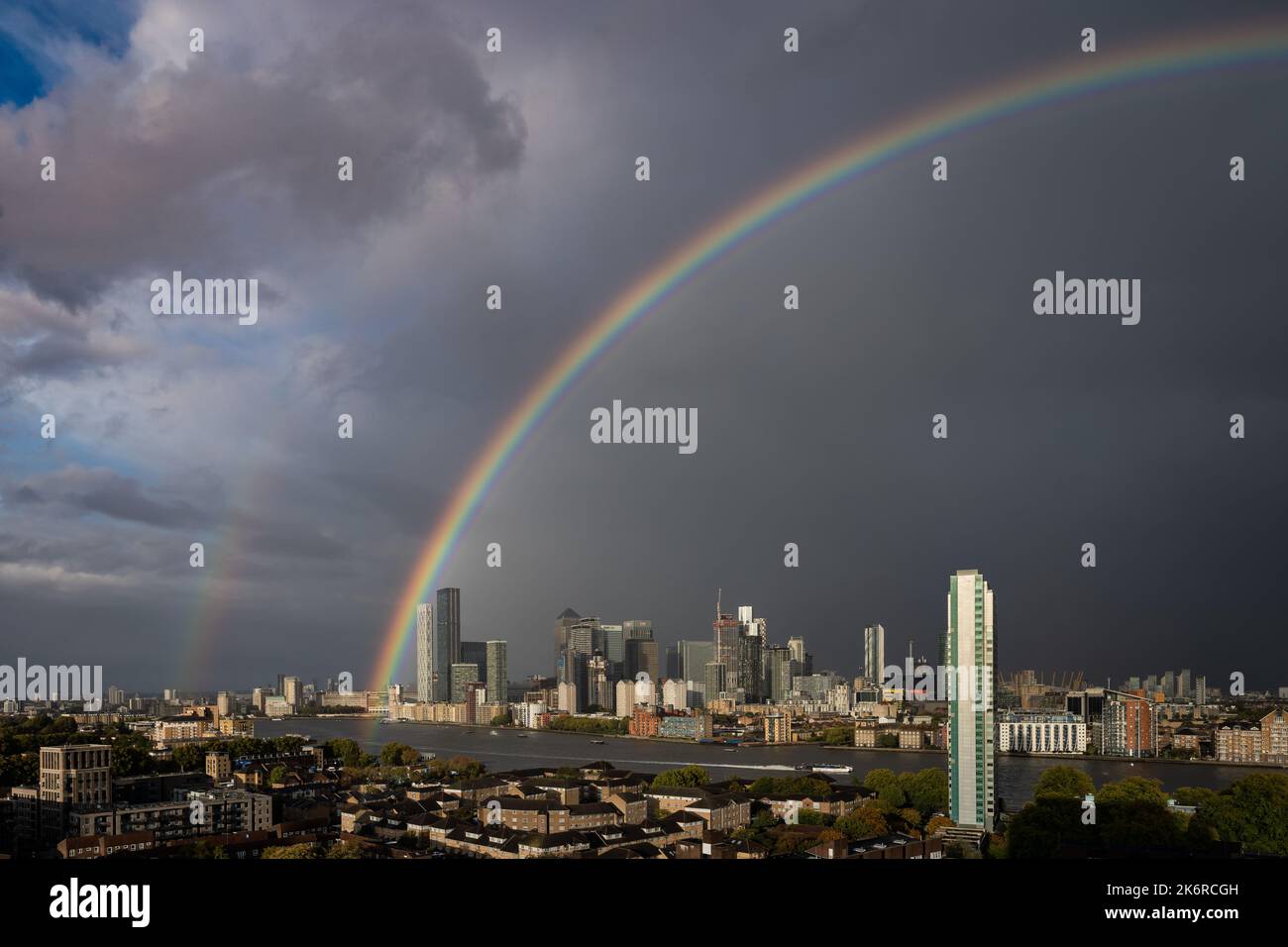 London, UK. 15th October, 2022. UK Weather: A massive rainbow breaks ...
