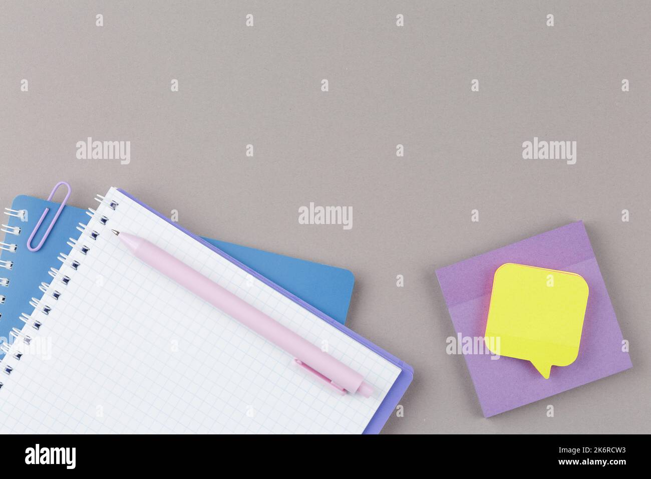 Notepad with school supplies on gray desk Stock Photo - Alamy