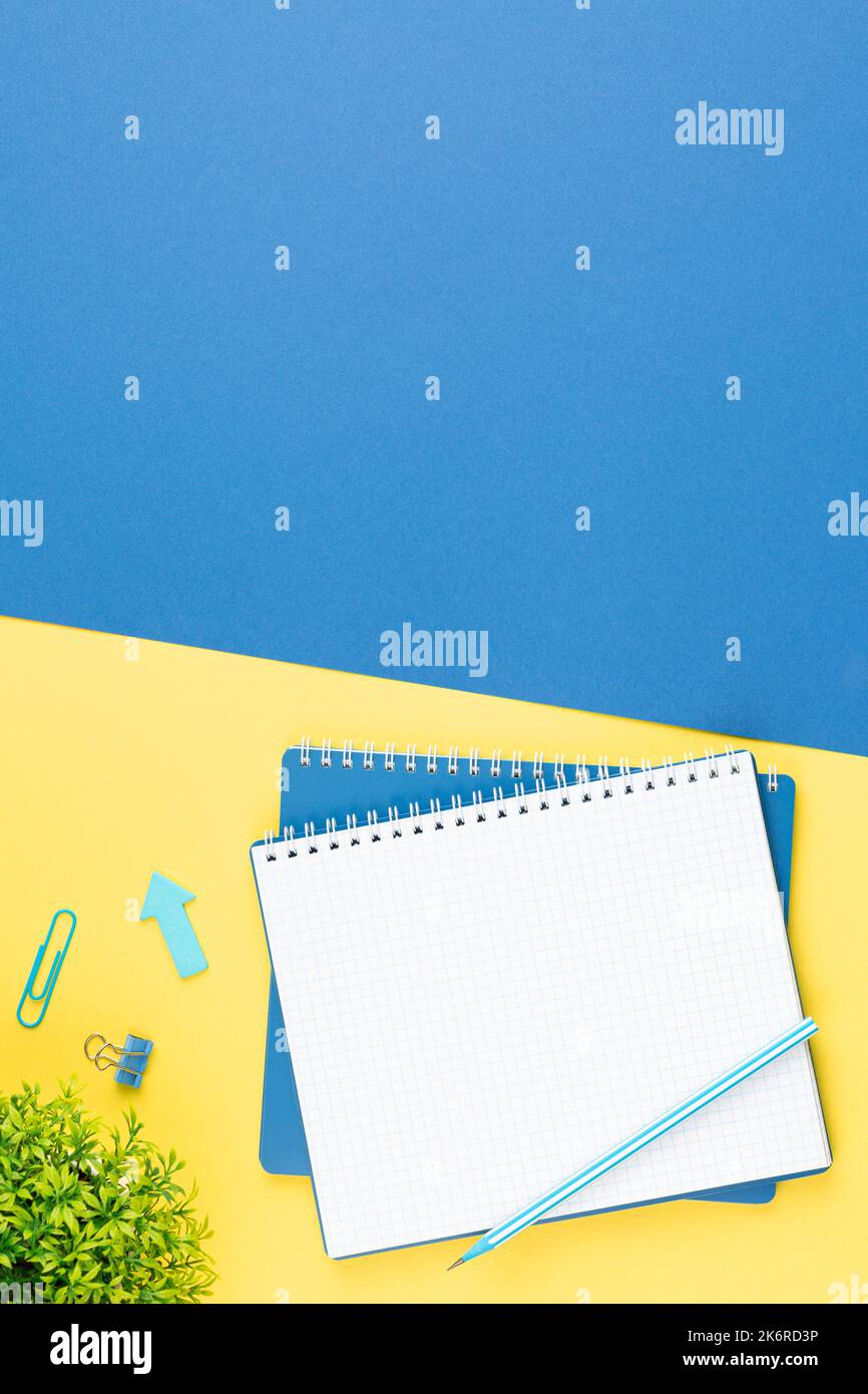 Spiral notepad with stationery on office table Stock Photo - Alamy