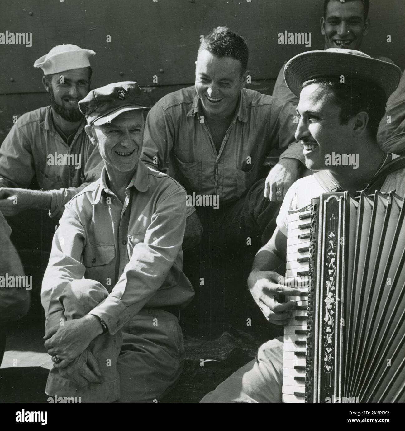 Photograph of Ernie Pyle with Troops listening to Private First Class ...