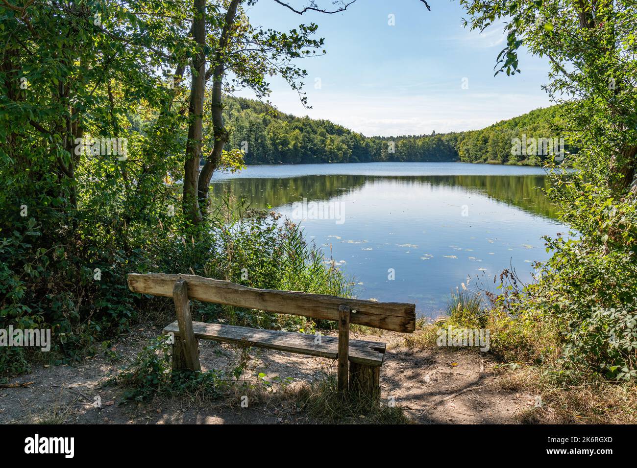 Wooden Bench at the Obersee lake of the ville chain of lakes in the ...