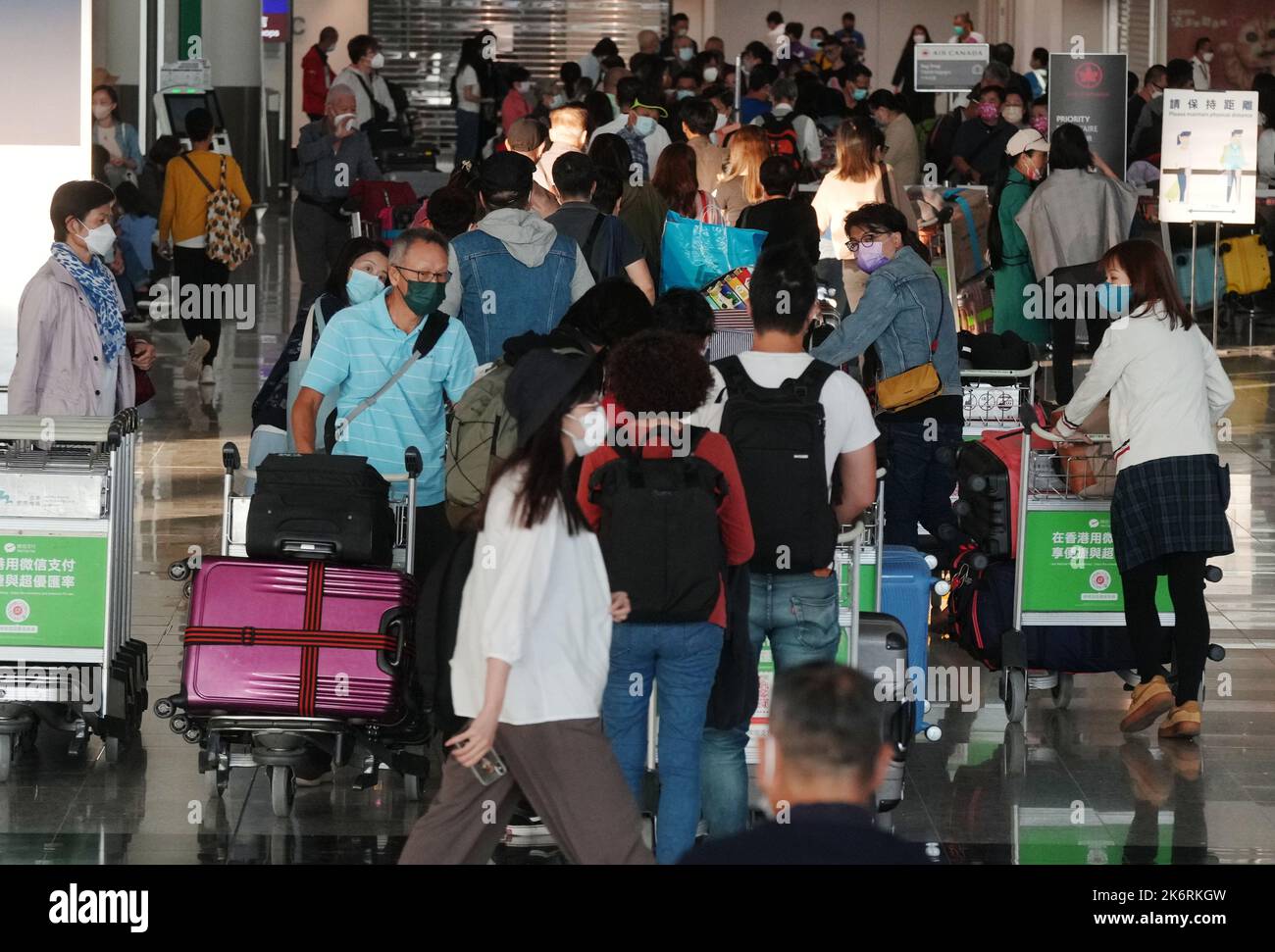 Outbound passengers queue up at check-in counter at the departure hall ...