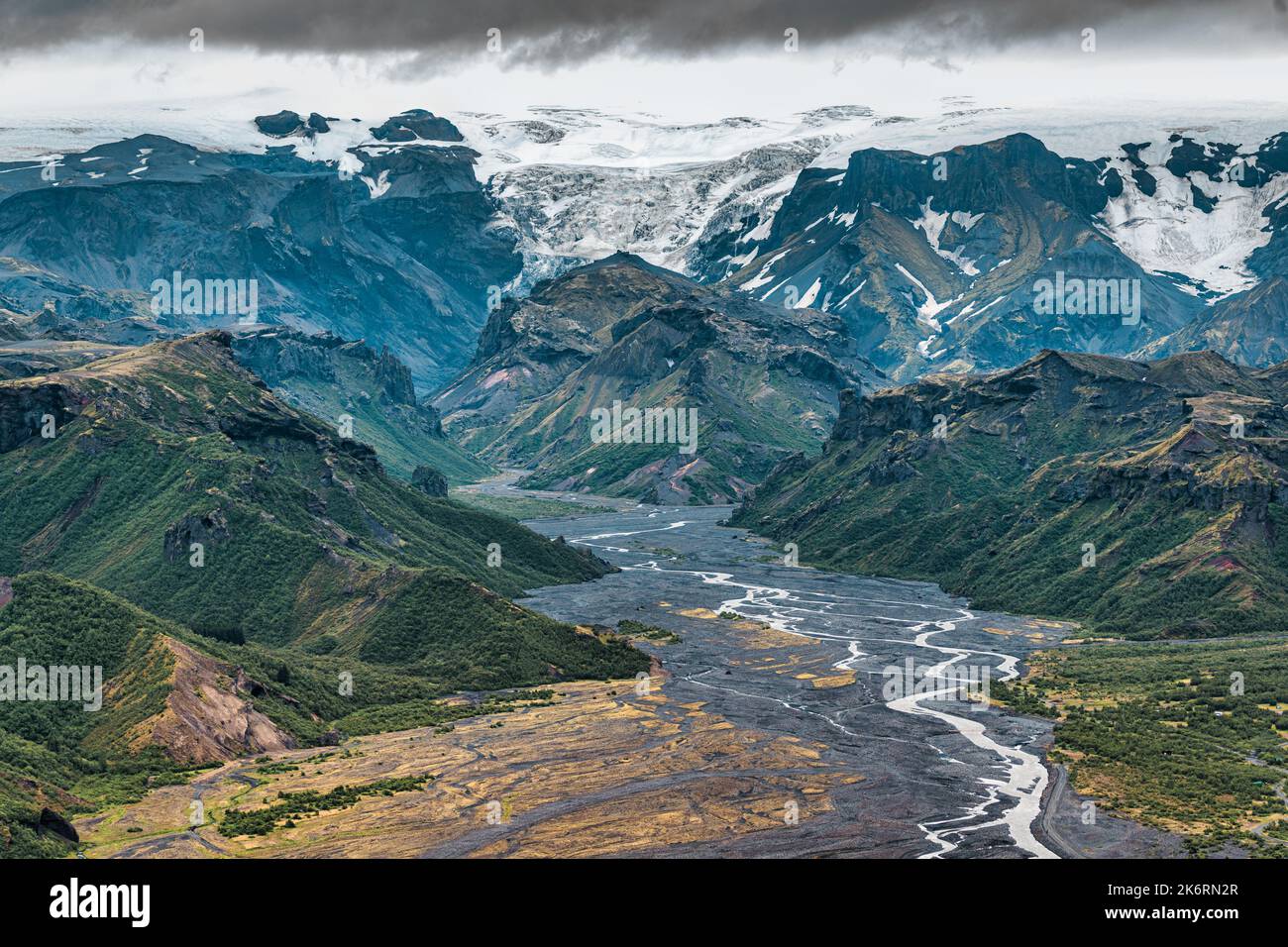 Majestic green mountain canyon with snow covered and river in Icelandic ...