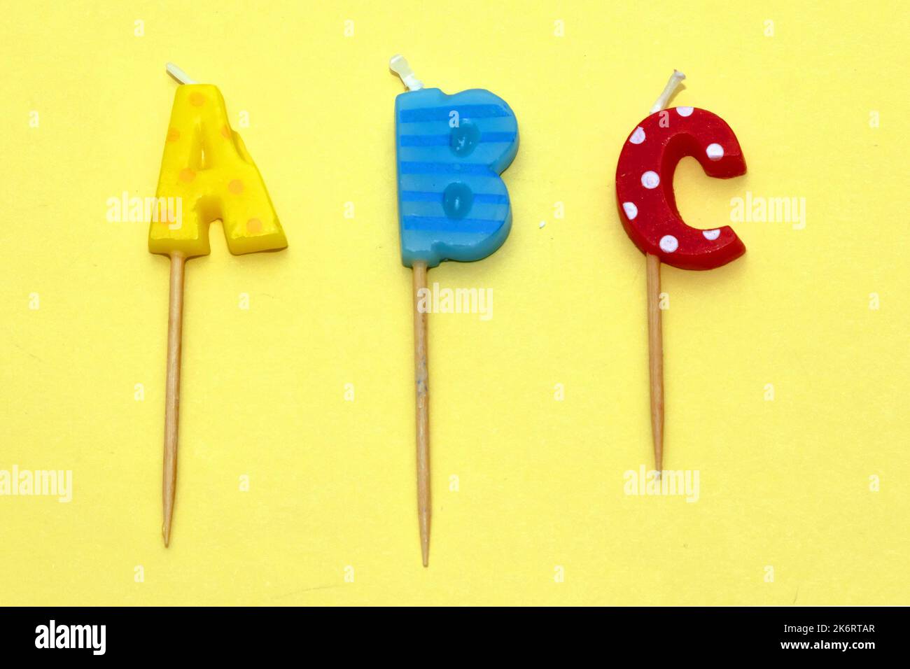 ABC alphabet colorful candles text letters isolated on yellow ...