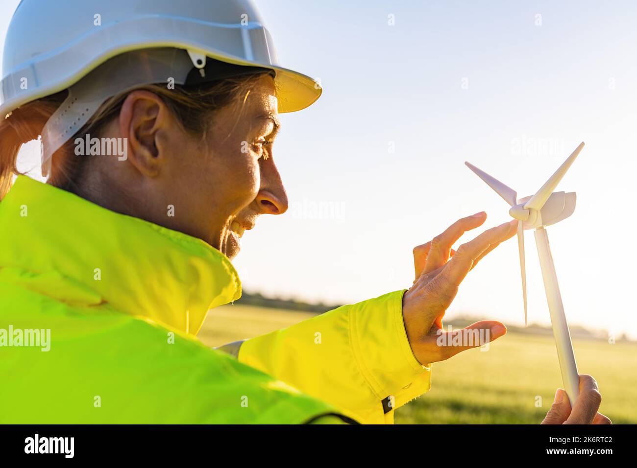 female engineer holding wind turbine model and play with propellers at ...