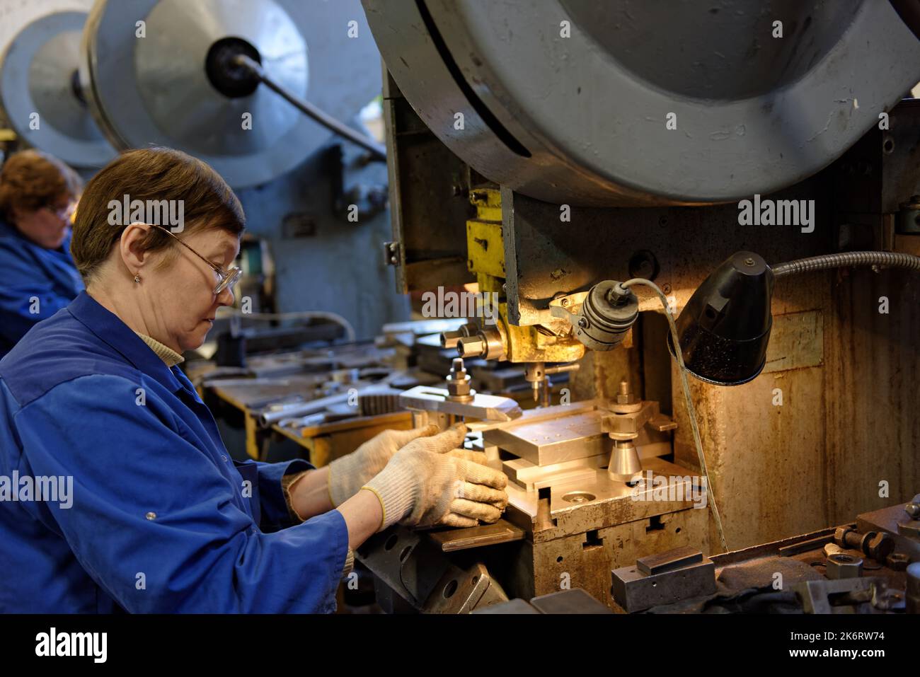 Female workers of the holding Lenpolygraphmash on their workplaces. The ... Female workers of the holding Lenpolygraphmash on their workplaces. The ...