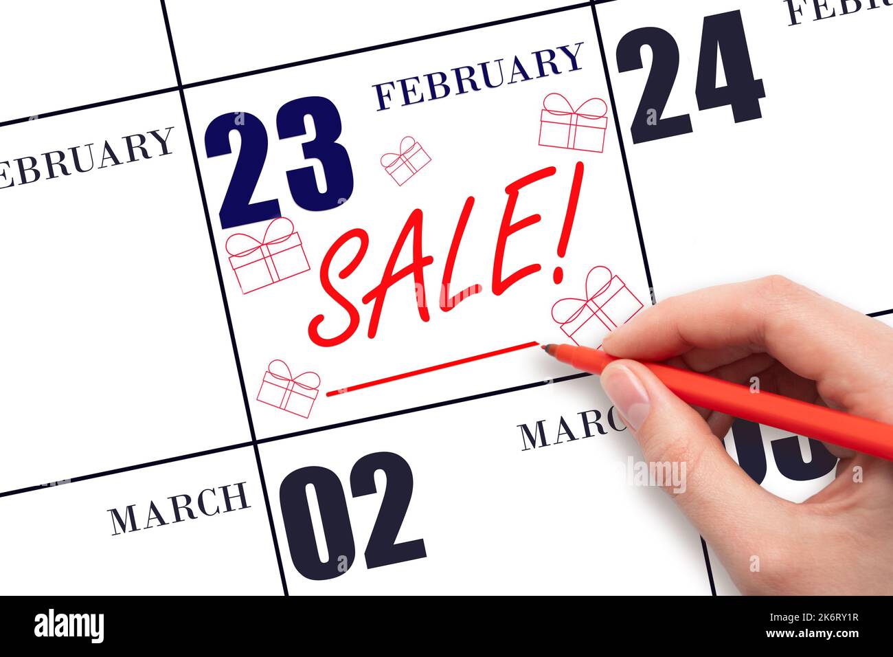 23rd day of February. Hand writing text SALE and drawing gift boxes on ...