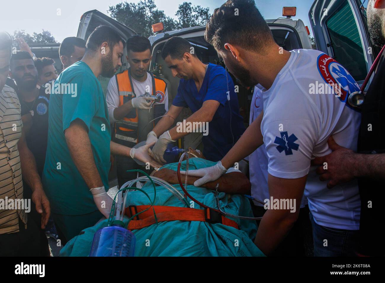 Palestinian paramedics transport an injured Palestinian Mujahid Daoud ...