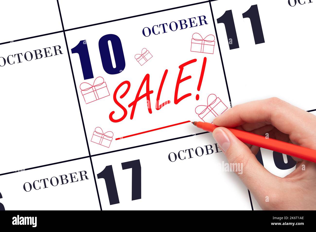 10th day of October. Hand writing text SALE and drawing gift boxes on ...