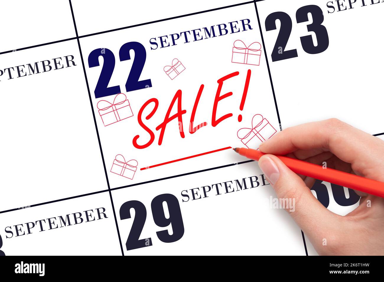 22nd day of September. Hand writing text SALE and drawing gift boxes on ...