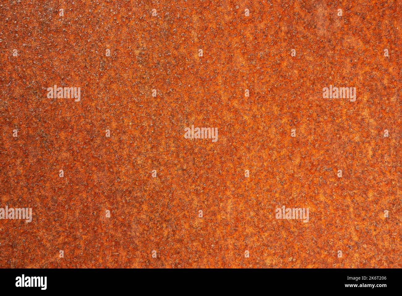 The background is a rusty orange metal surface for an inscription or ...