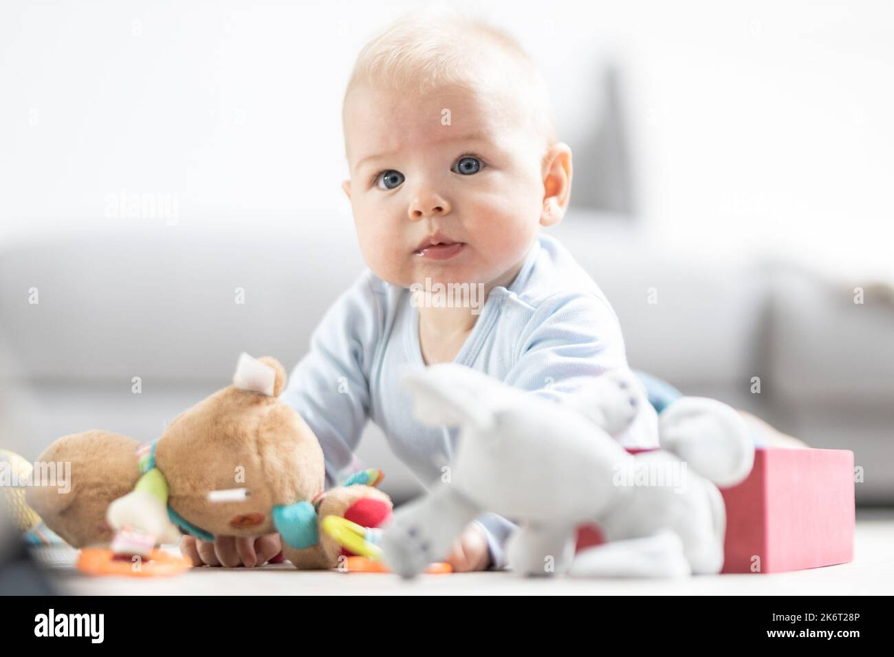 Cute baby boy playing with toys on mat at home Baby activity and play ...