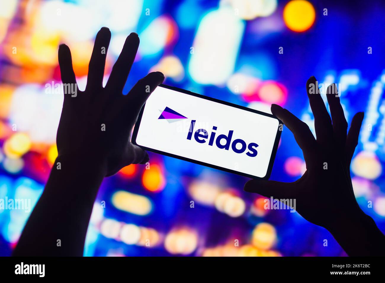 In this photo illustration, the Leidos logo is displayed on a ...