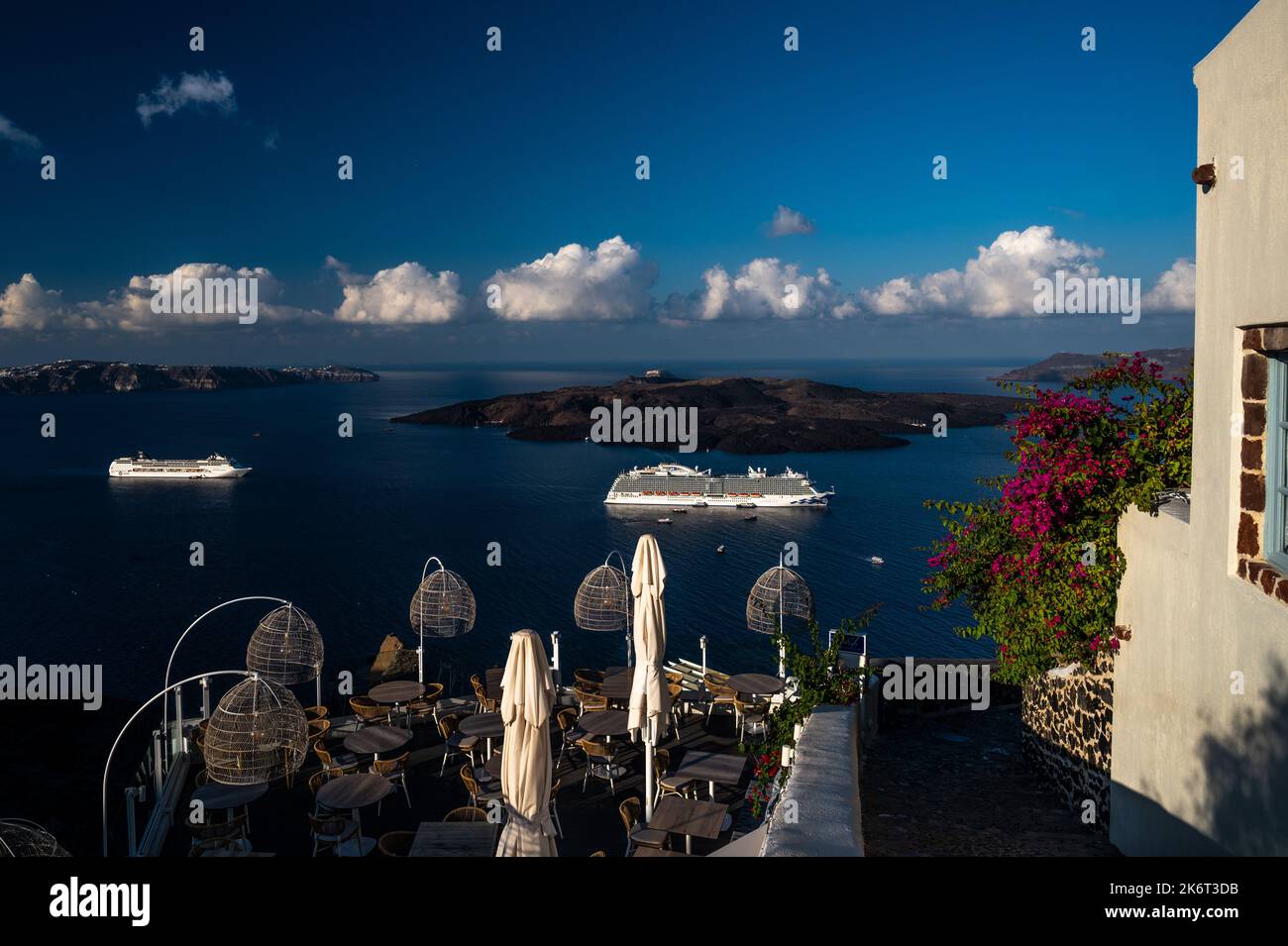 Cruise ships are seen arriving in Santorini with tourists. Santorini is ...