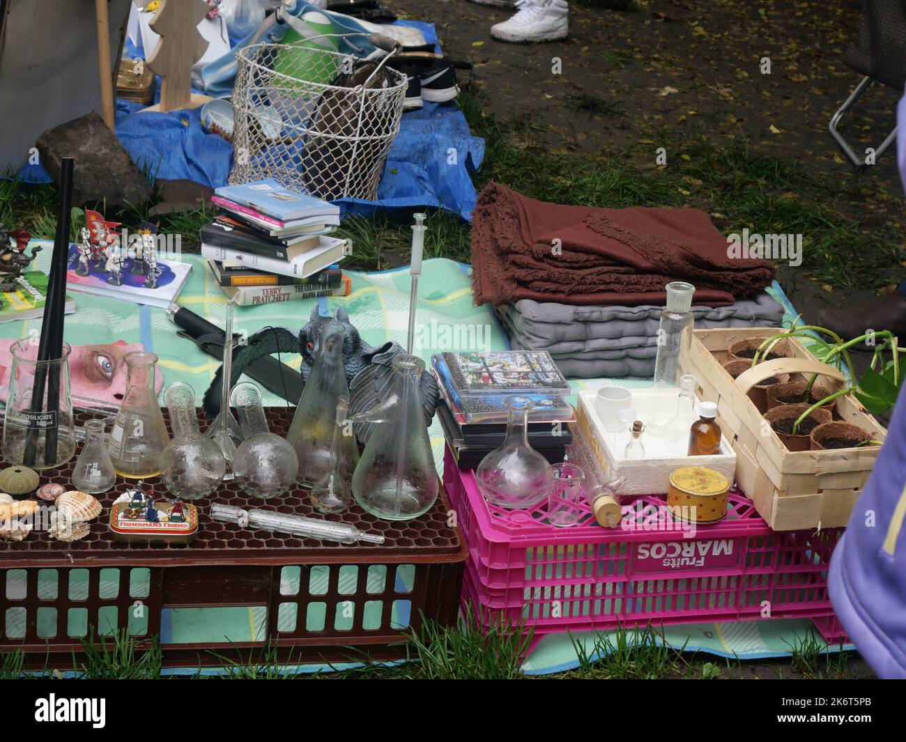 Flea market in a garden, many thing to sell, unrecognisable people and ...