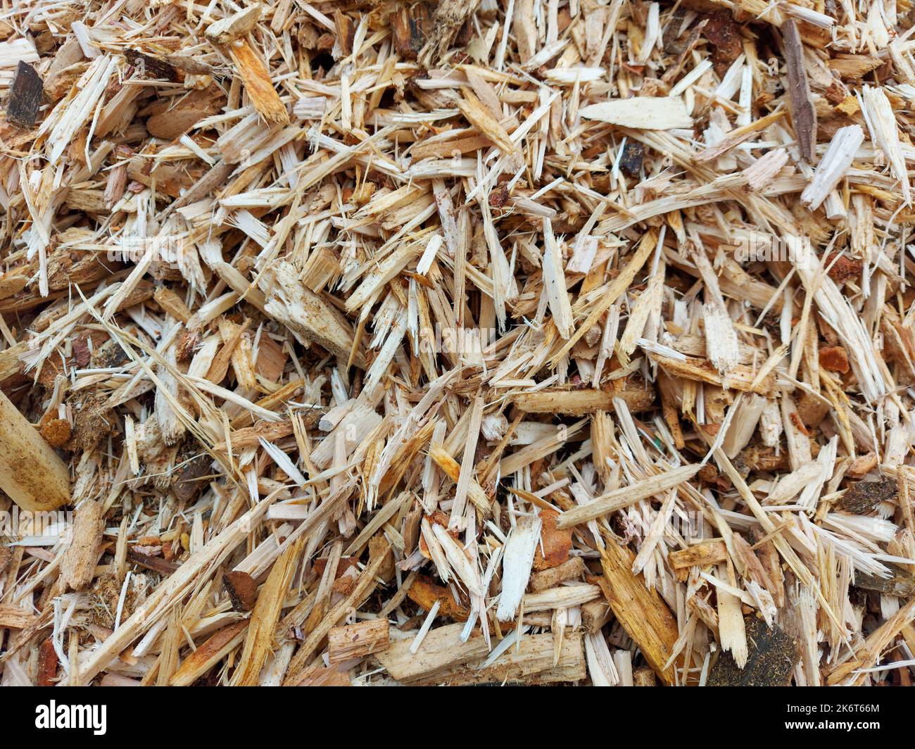 Small pile of wood chips background, top view. Waste from the ...