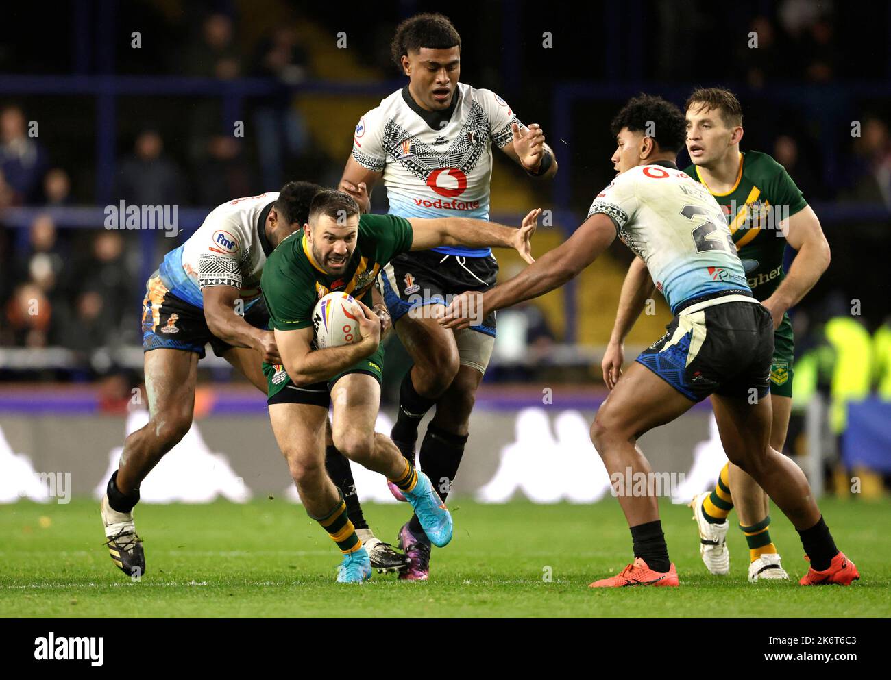 Australia's James Tedesco attempts to get past Fiji's Josh Wong (second ...