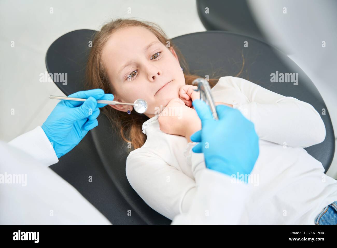 Pre-teen girl feeling scared of upcoming tooth extraction Stock Photo ...