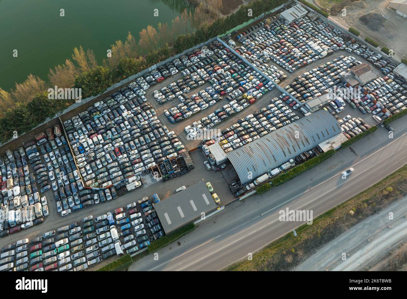 Aerial view of big parking lot of junkyard with rows of discarded ...