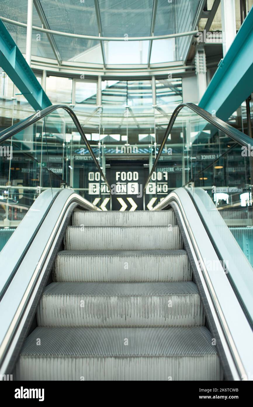 Escalator. View from below. Blue background. inside Stock Photo - Alamy