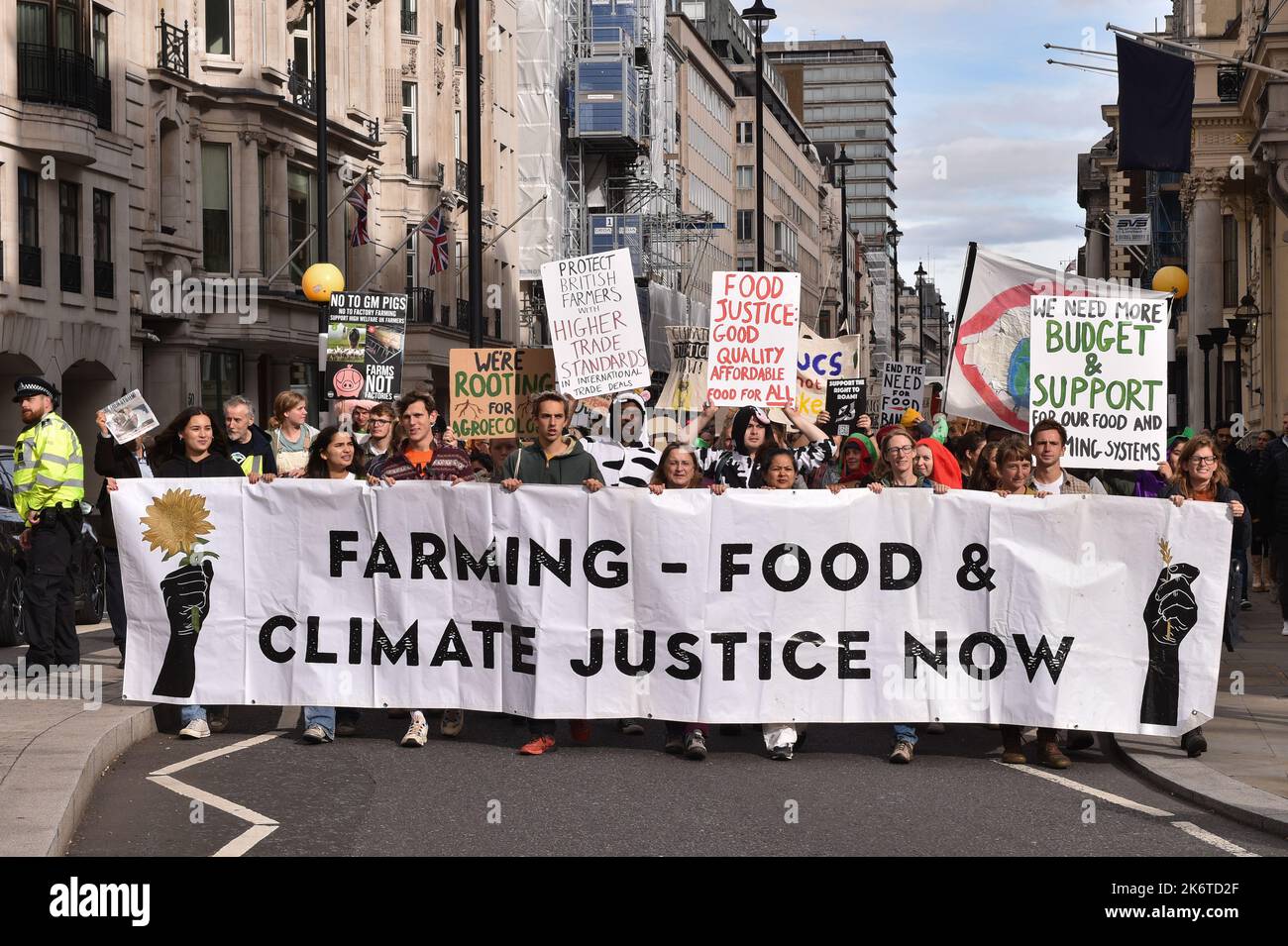 Protesters hold a banner and placards during the rally in Central ...