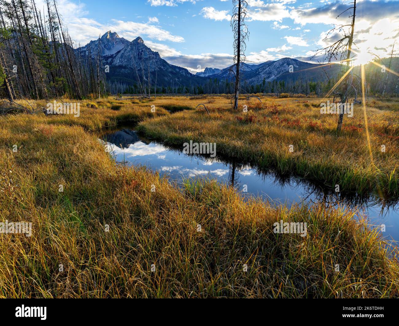 McGowan and sunburst from a marsh stream with reflection Stock Photo ...