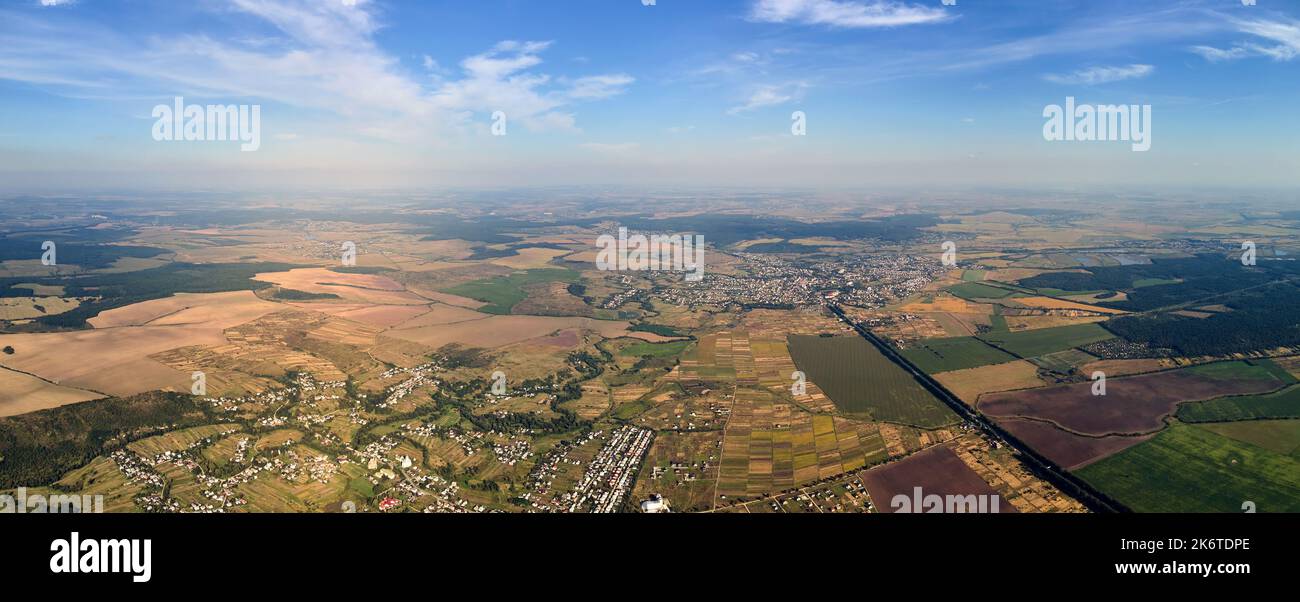 Aerial view of farm fields and distant scattered houses in rural area ...
