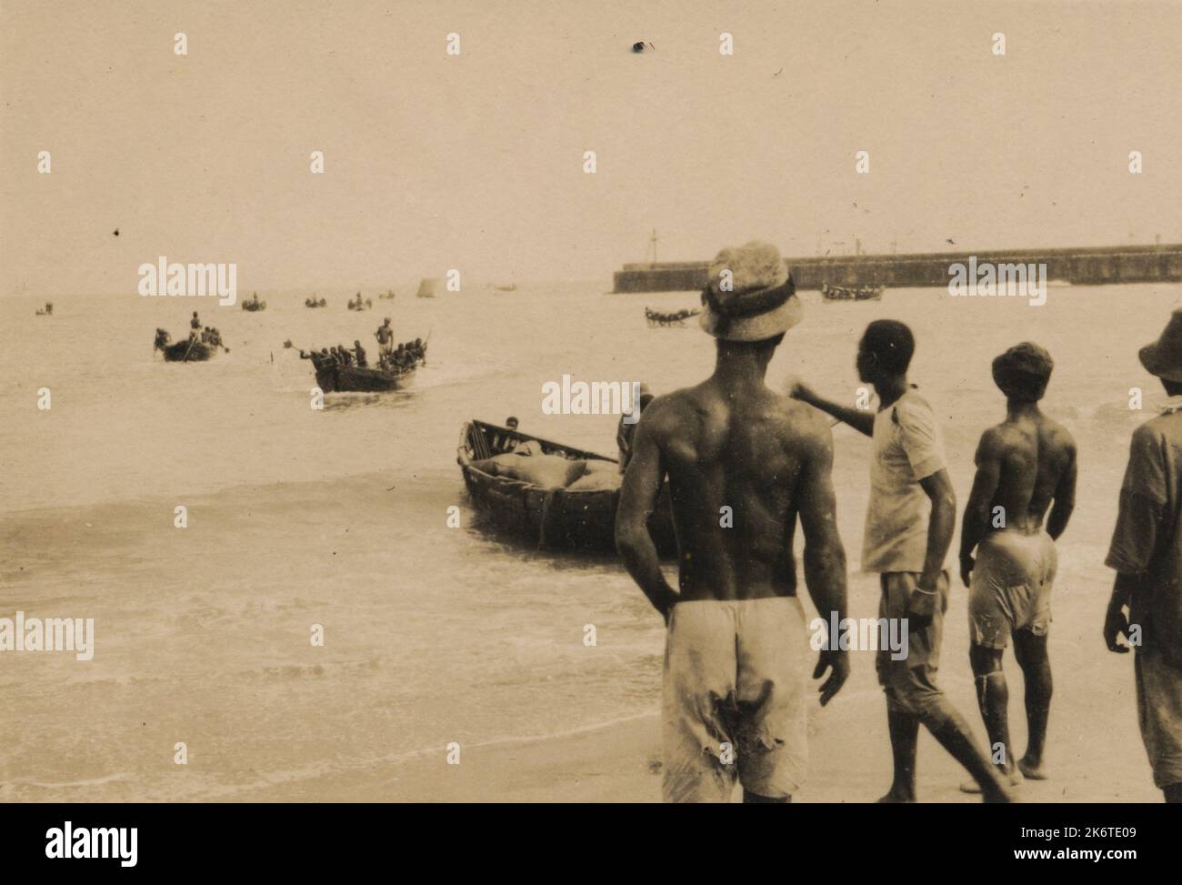 South Africa 1930s, People look out to boats on the sea in this ...