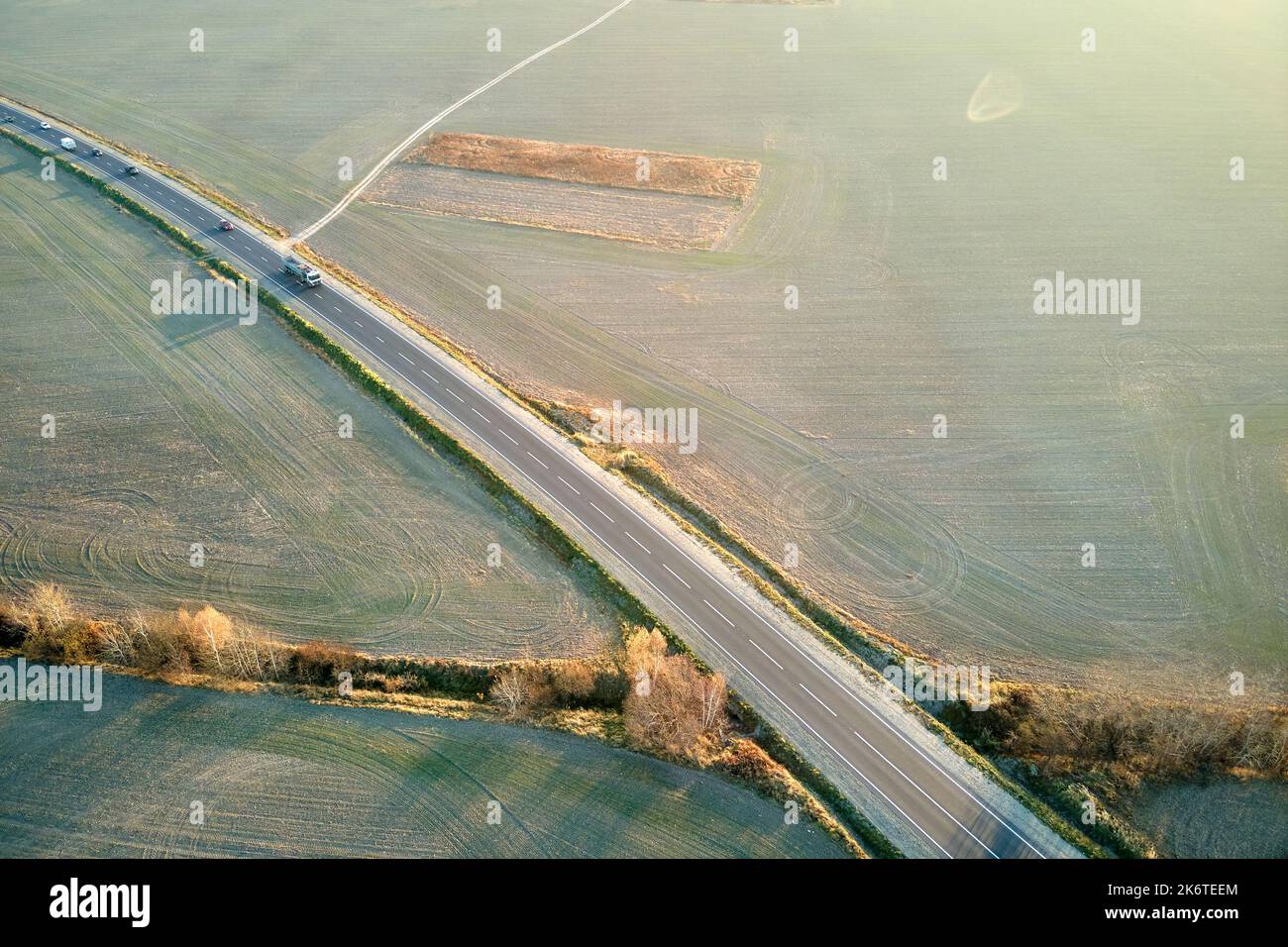 Aerial view of intercity road with fast driving cars at sunset. Top ...